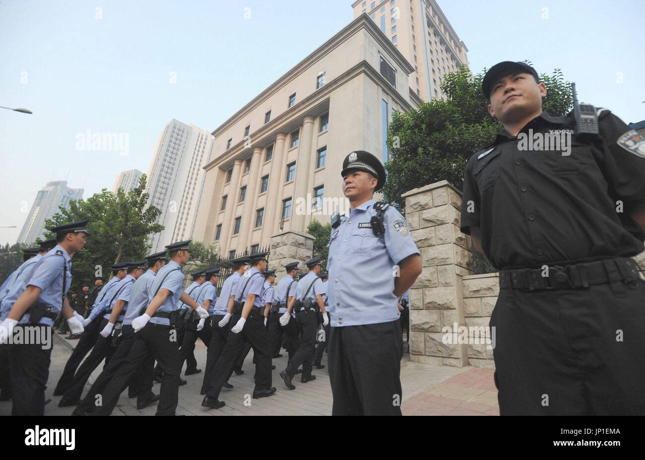 JINAN, China - Police officers are mobilized as the trial began for ...