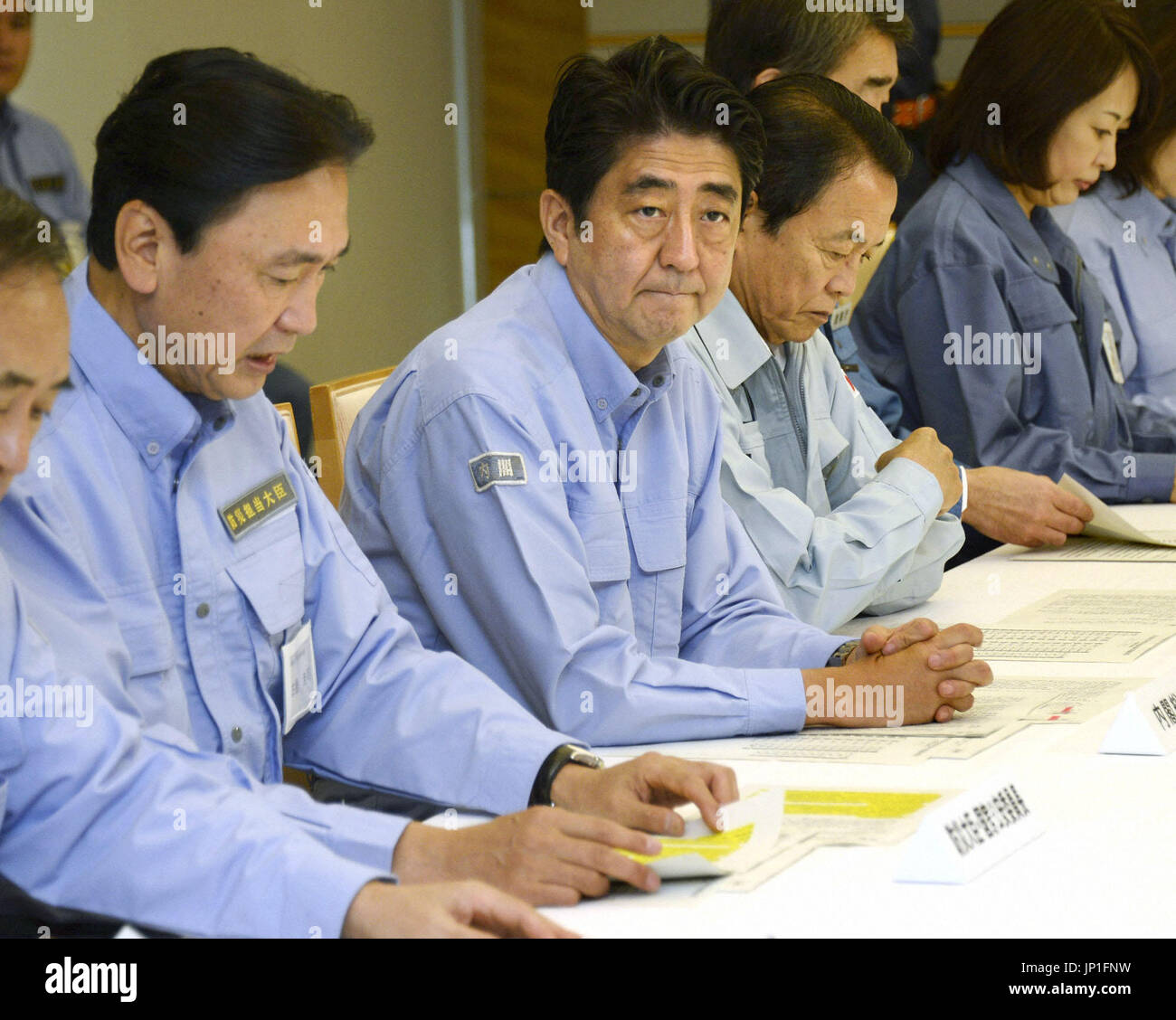 TOKYO, Japan - Prime Minister Shinzo Abe (C) and Keiji Furuya (to the ...