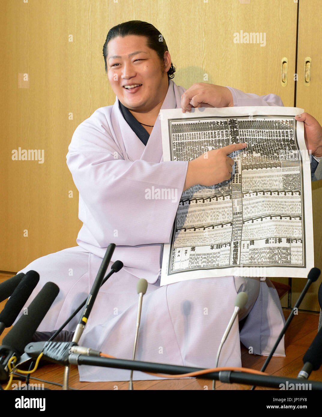 TOKYO, Japan - Sumo wrestler Endo points to his name on a new sumo ...
