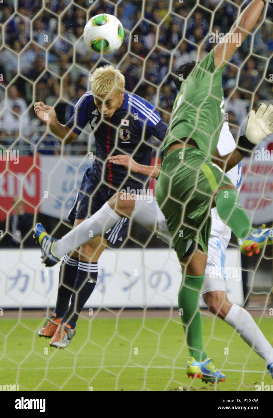 OSAKA, Japan - Japan midfielder Keisuke Honda (L) heads home the team's ...