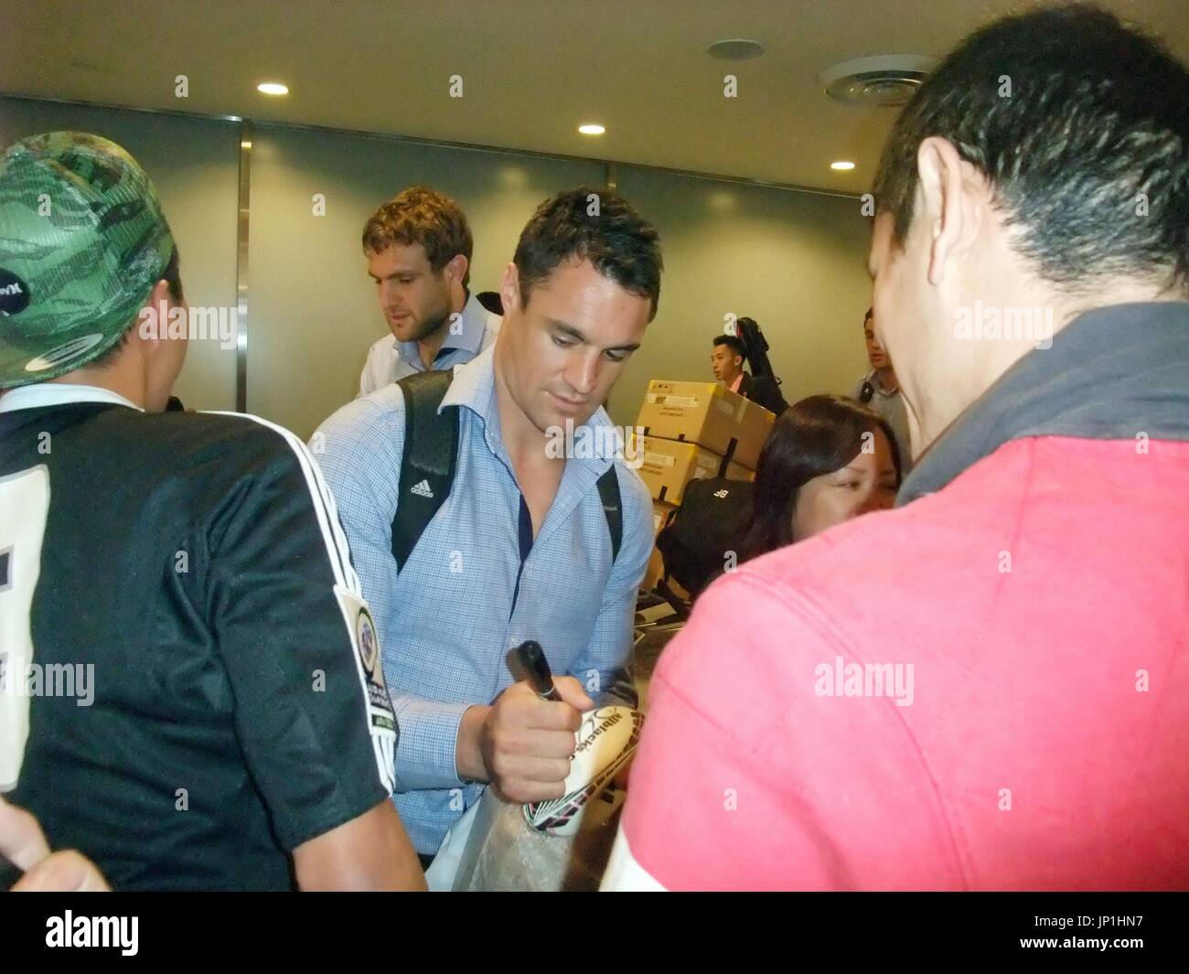 NARITA, Japan - All Blacks flyhalf Dan Carter signs an autograph for a ...