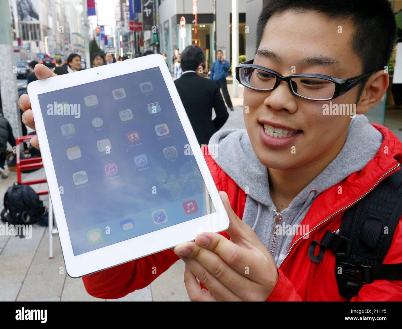 TOKYO, Japan - A man shows off an Apple Inc. iPad Air tablet computer ...