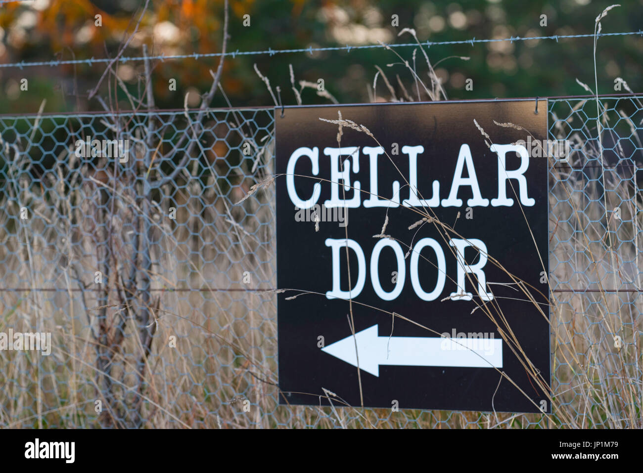 A cellar door sign attached to a fence at a winery in NSW, Australia ...