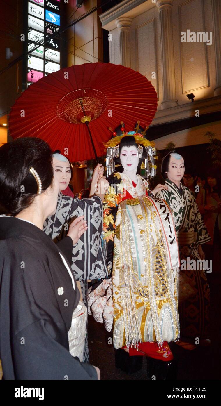 OSAKA, Japan - Men and women wearing feudal costumes walk during the ...