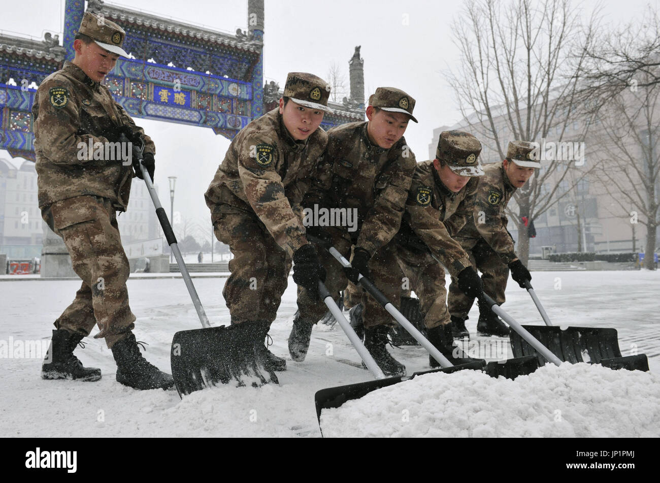 BEIJING, China - Soldiers of the People's Liberation Army remove snow ...
