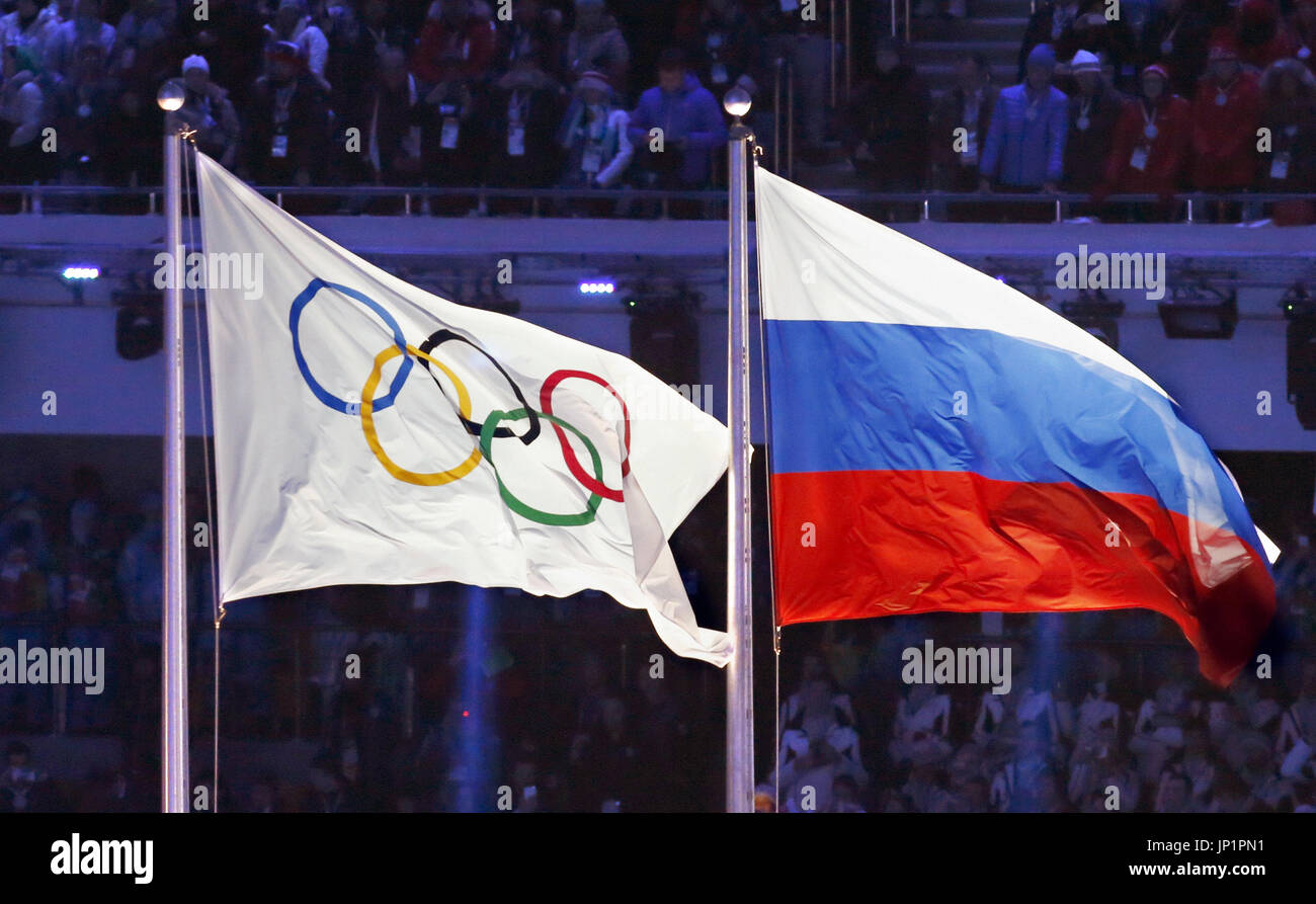 SOCHI, Russia - The Olympic flag (L) and the Russian national flag are ...