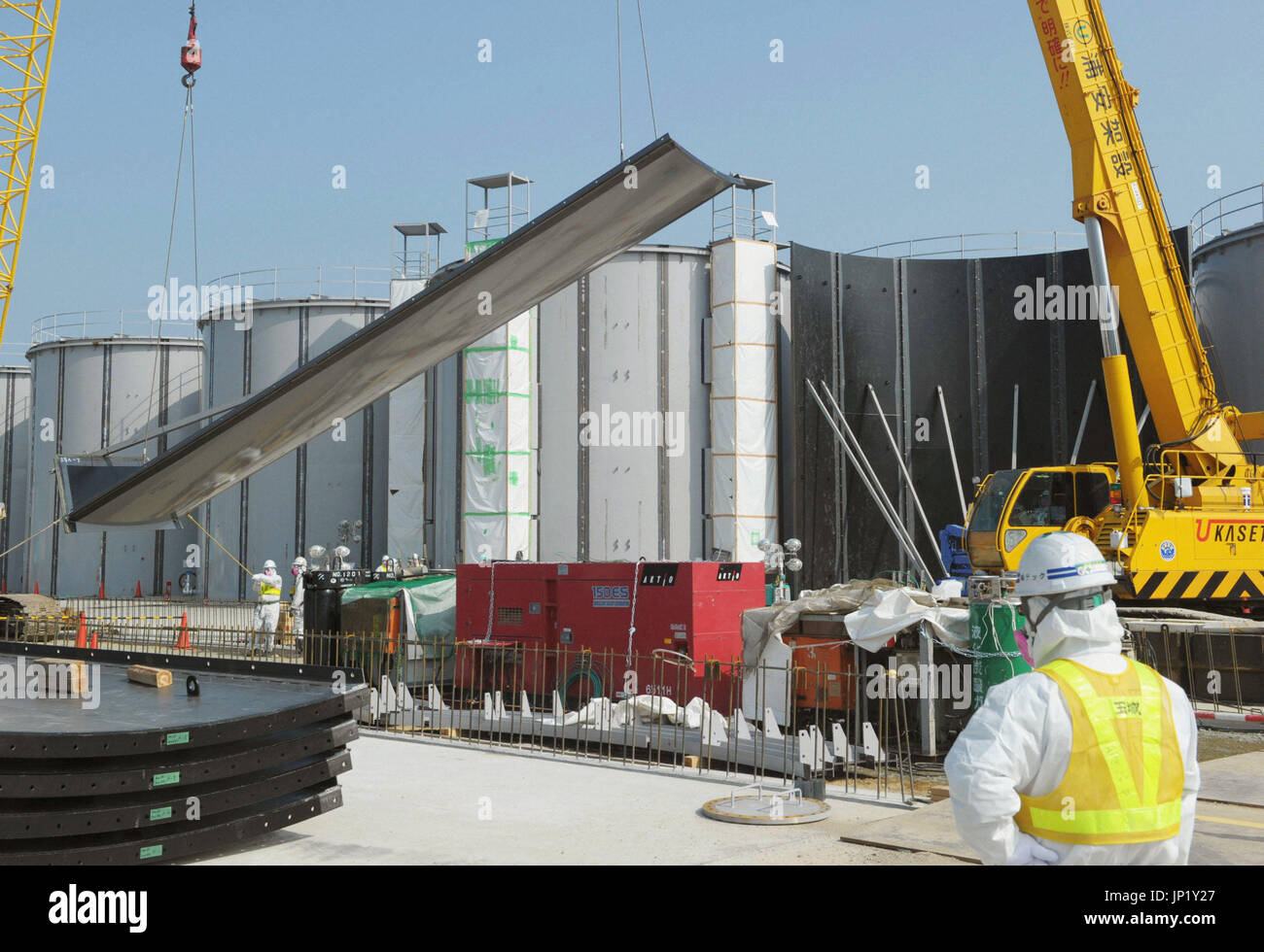 TOKYO, Japan - Welded tanks are seen being built above ground at the ...