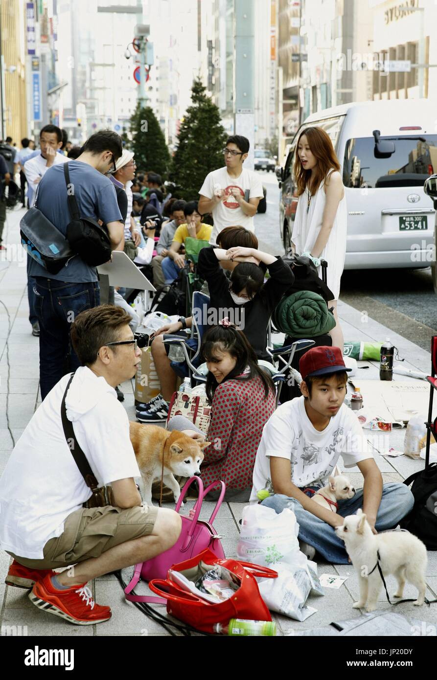 TOKYO, Japan - Customers line up outside Apple Store Ginza in Tokyo on ...