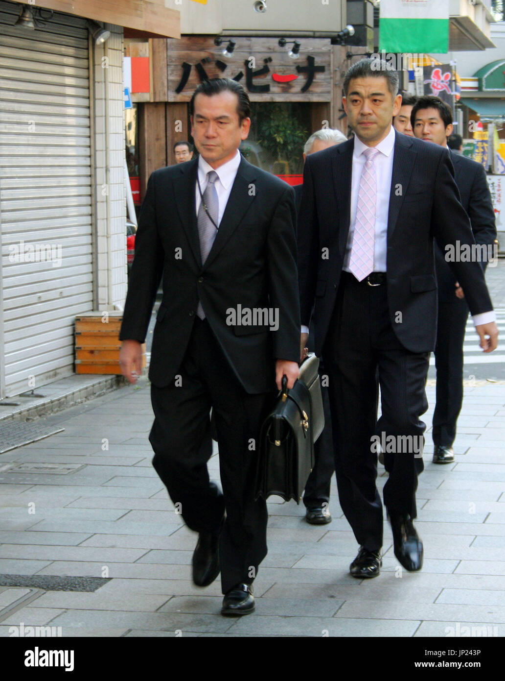TOKYO, Japan - Police investigators head to the office of the Mitsui ...