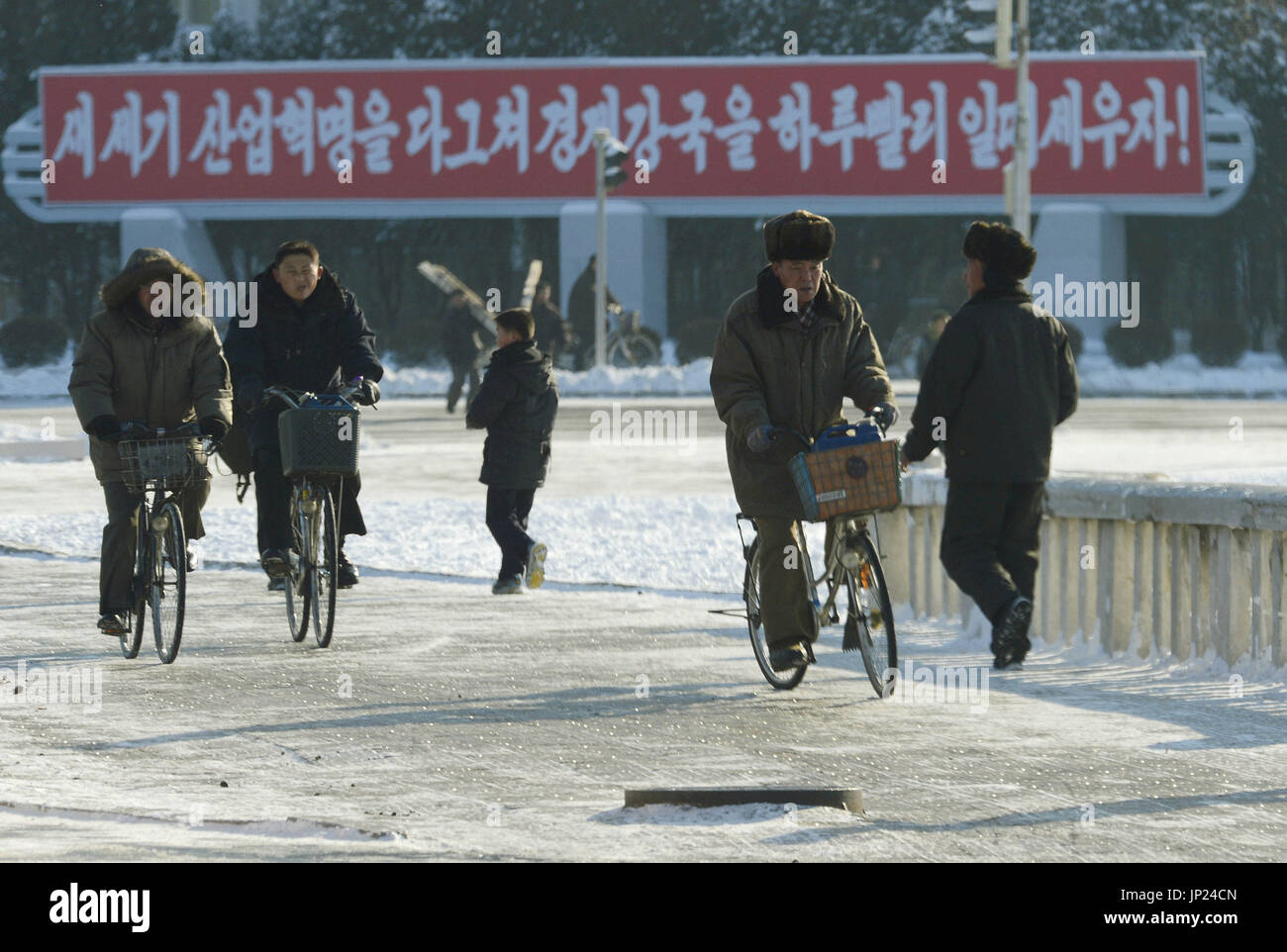 PYONGYANG, North Korea - People go by bicycle on a bridge in Pyongyang ...
