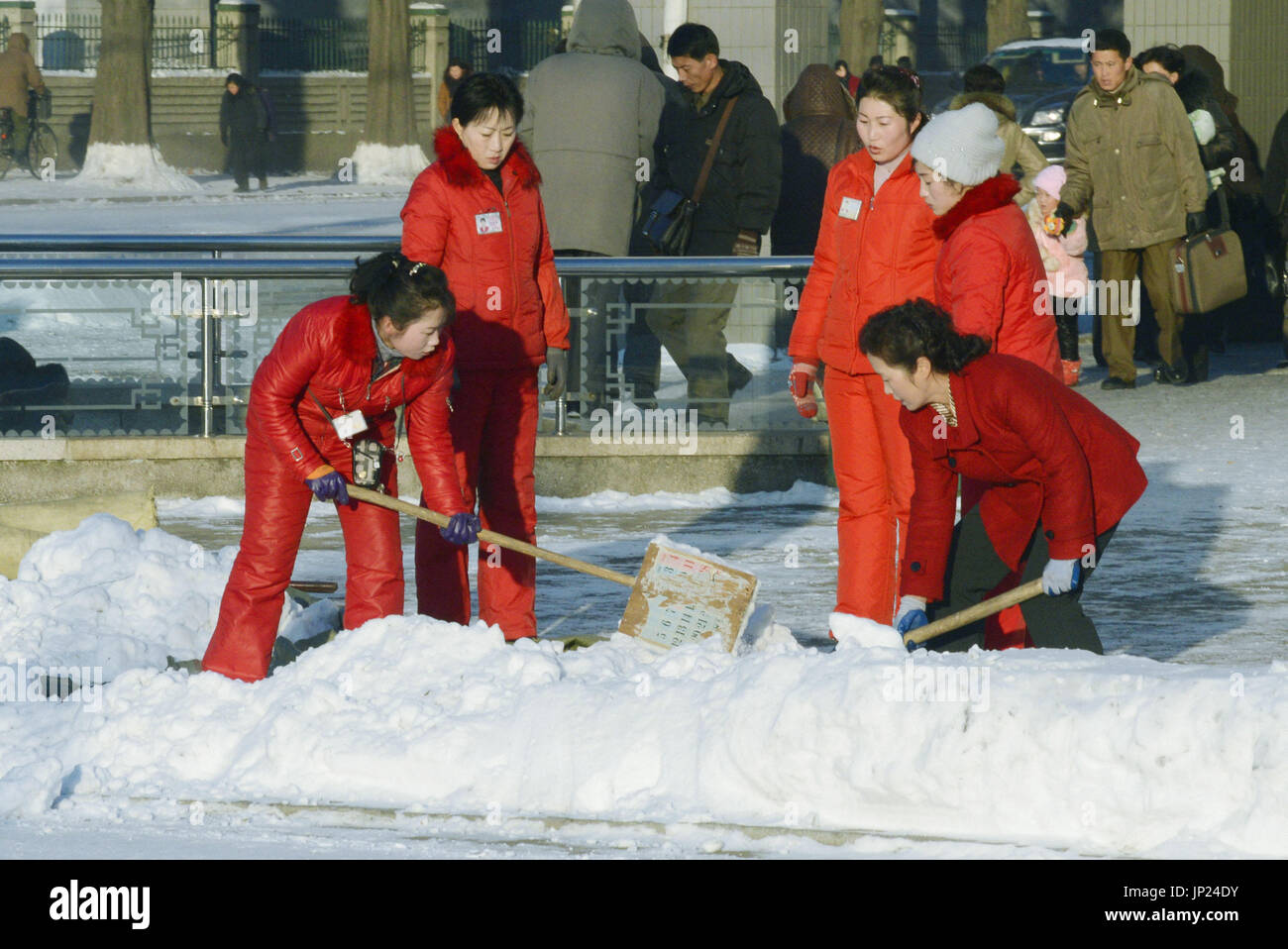 PYONGYANG, North Korea - Women remove snow near their workplace in ...