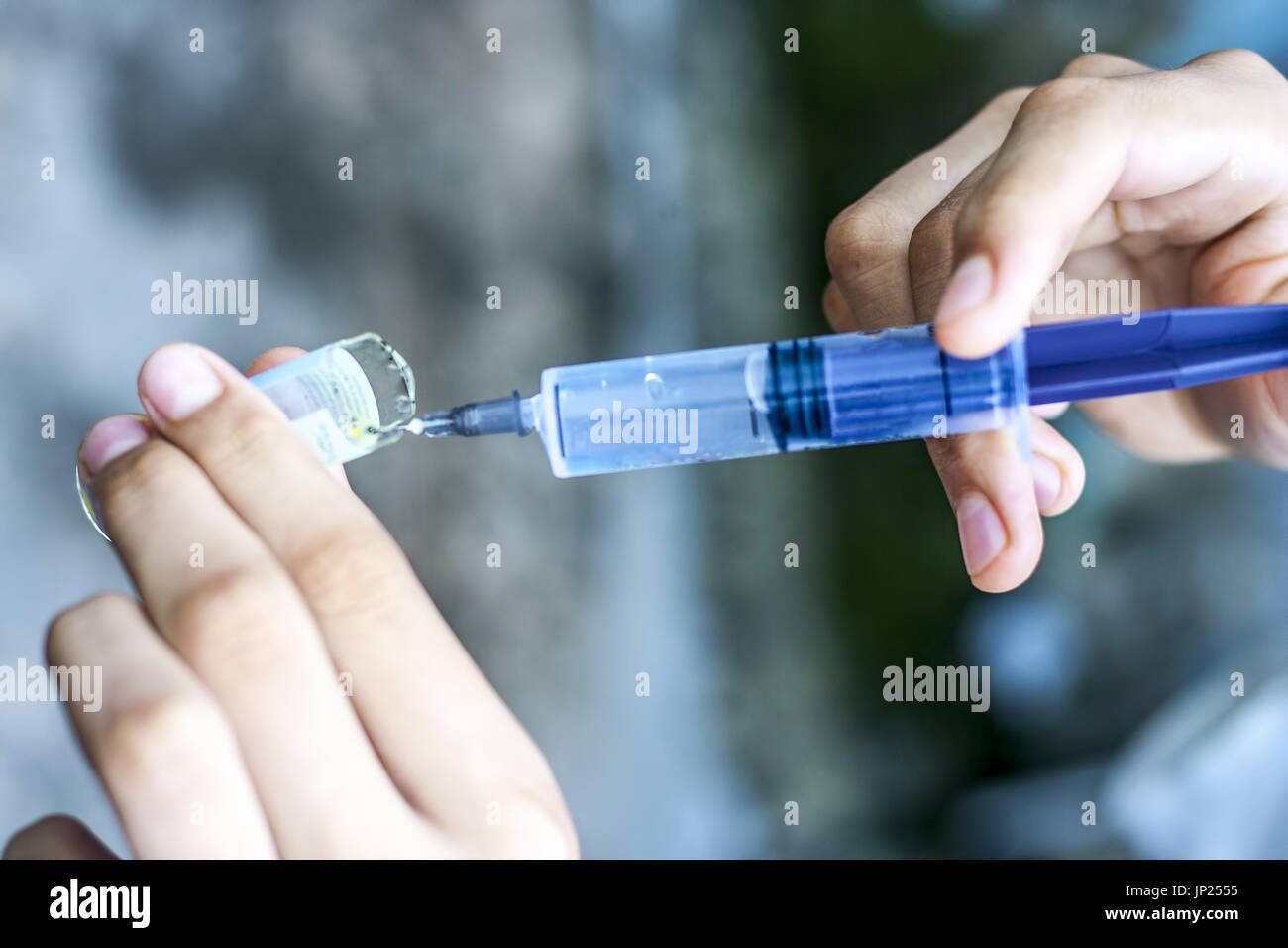 Syringe, medical injection, bottle, ampule in hand, palm or fingers ...