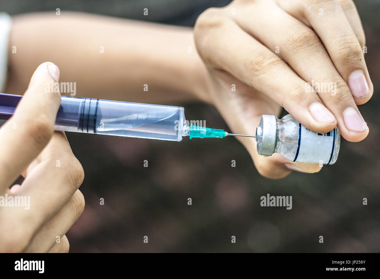 Syringe, medical injection, bottle, ampule in hand, palm or fingers ...