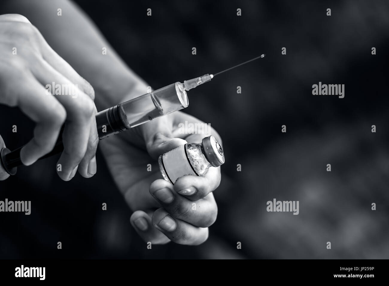 Syringe, medical injection, bottle, ampule in hand, palm or fingers ...