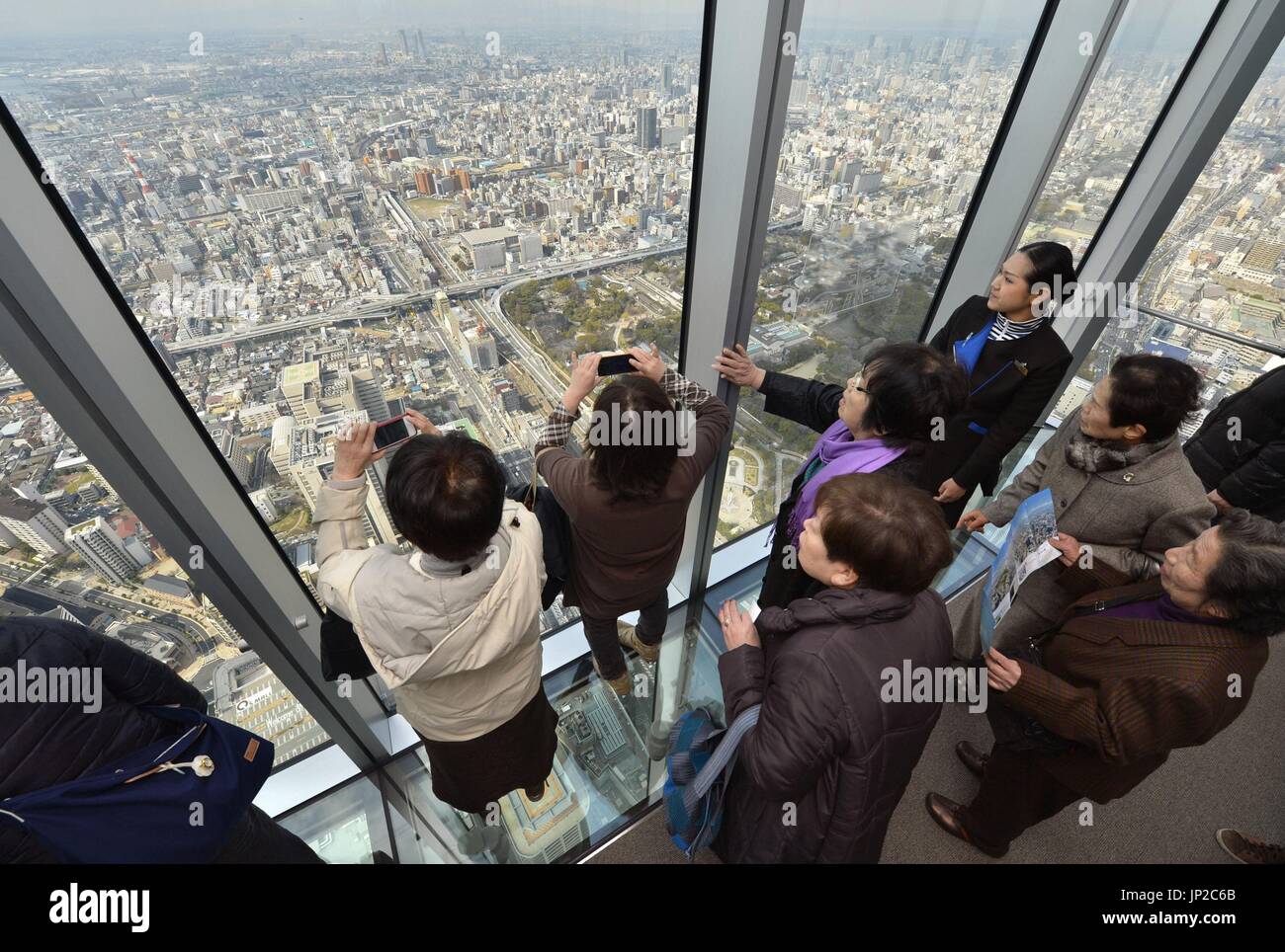 OSAKA, Japan - People look at the view from the observation deck of ...