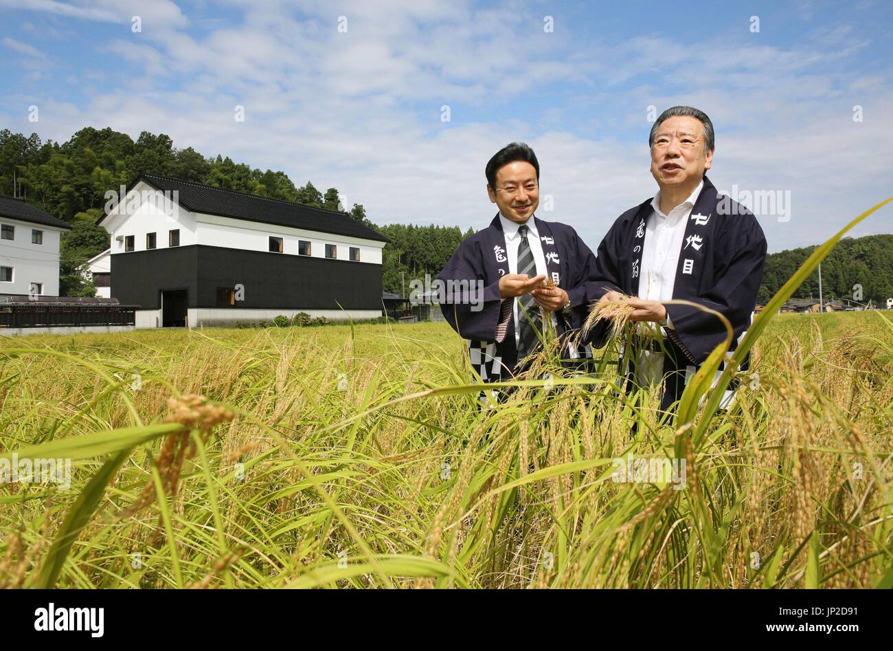 NAGAOKA, Japan - Norimichi Kusumi (R) and his son Yoshitaka hold rice ...