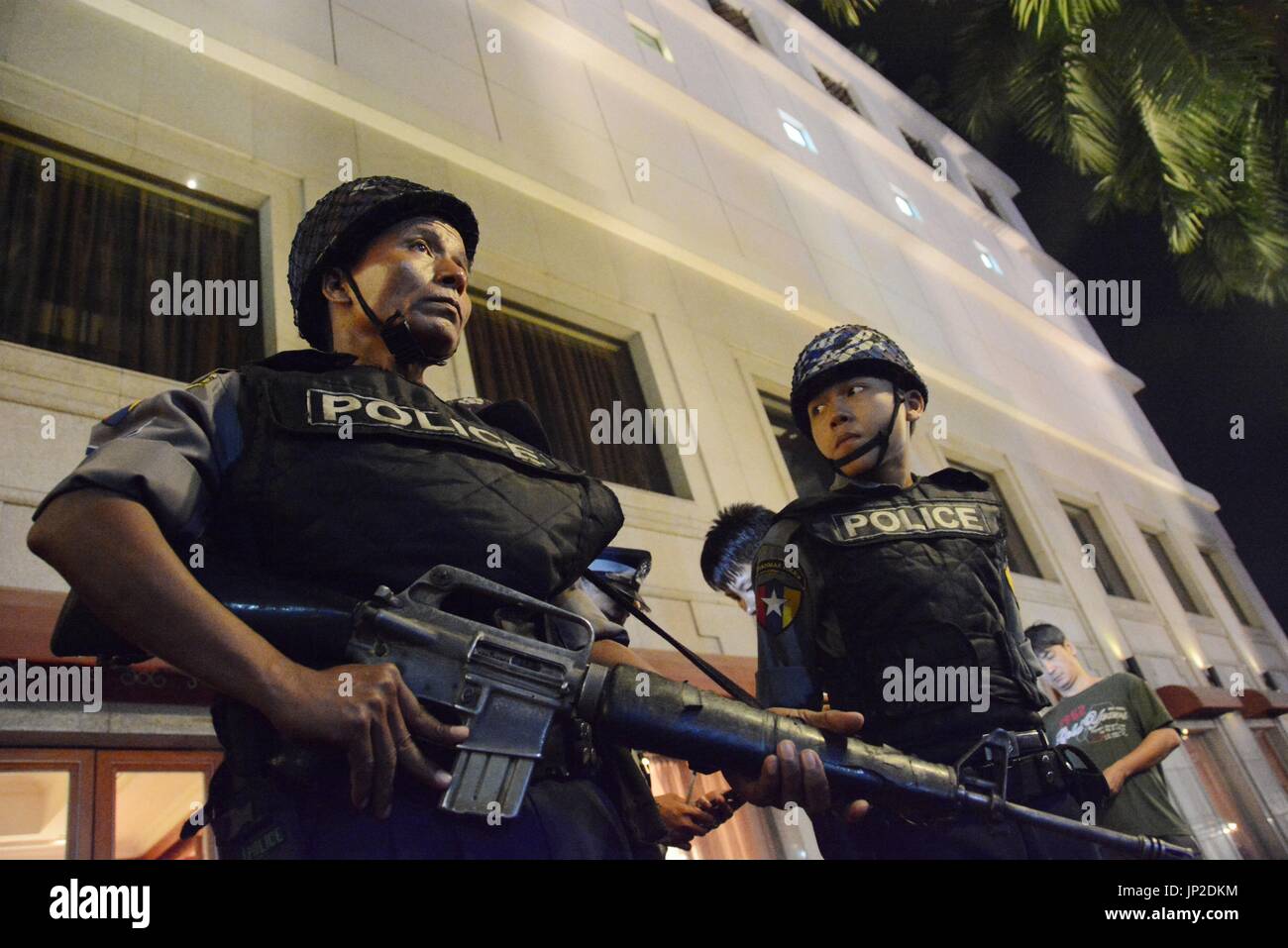 YANGON, Myanmar - Police officers stand guard at Traders Hotel in ...