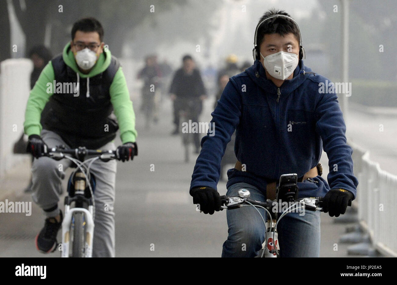 BEIJING, China - Cyclists wear masks in polluted air in Beijing, China ...