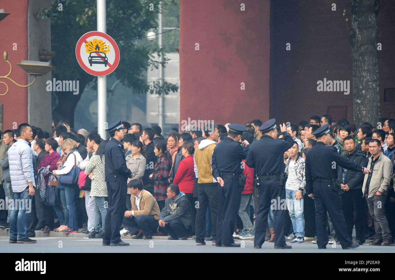 BEIJING, China - Police officers control traffic on a blockaded road ...