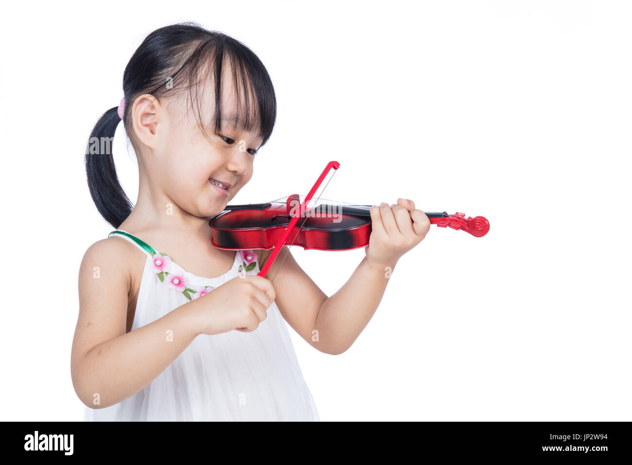 Asian chinese little girl playing violin in isolated white background ...