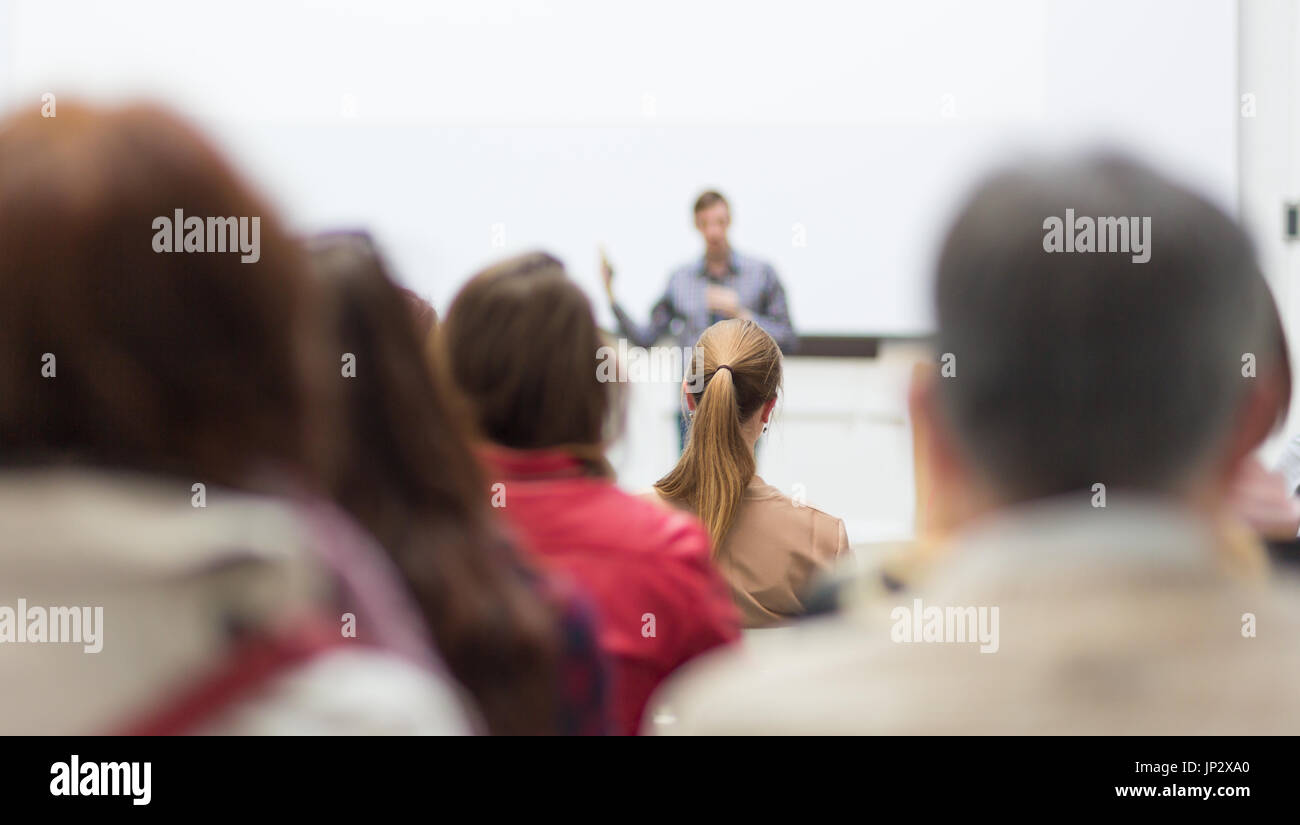Man giving presentation in lecture hall at university Stock Photo - Alamy