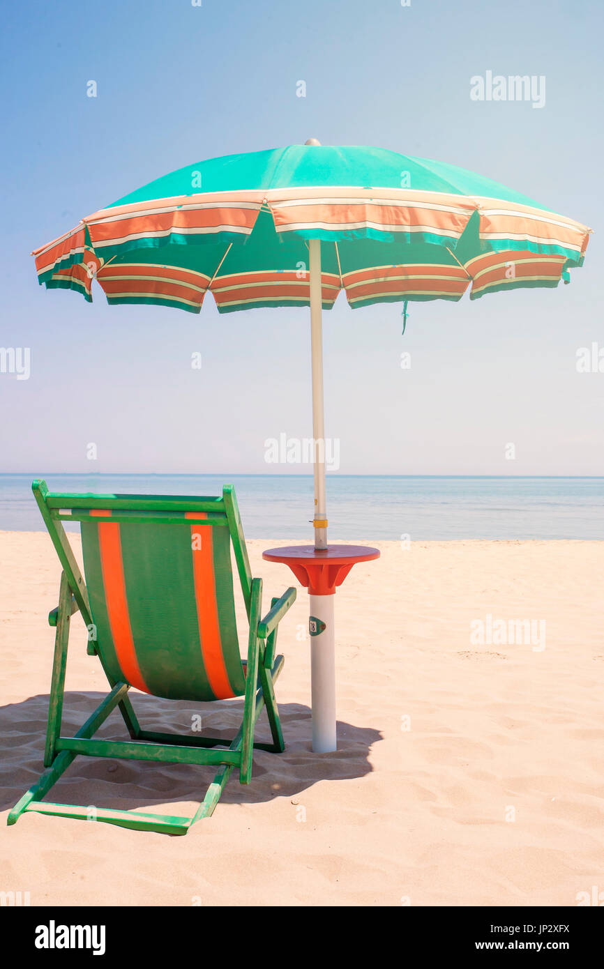 Beach chair and parasol sunshade Stock Photo - Alamy