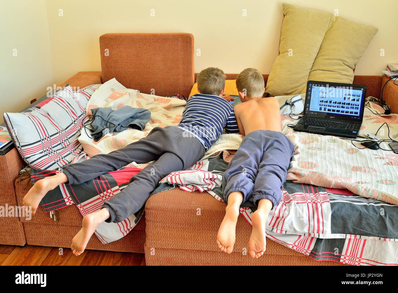 Kids in bed, playing computer Stock Photo - Alamy