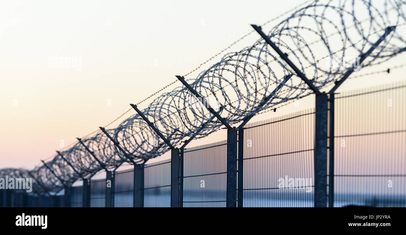Sharp barbed wire on fence at cold winter Stock Photo - Alamy