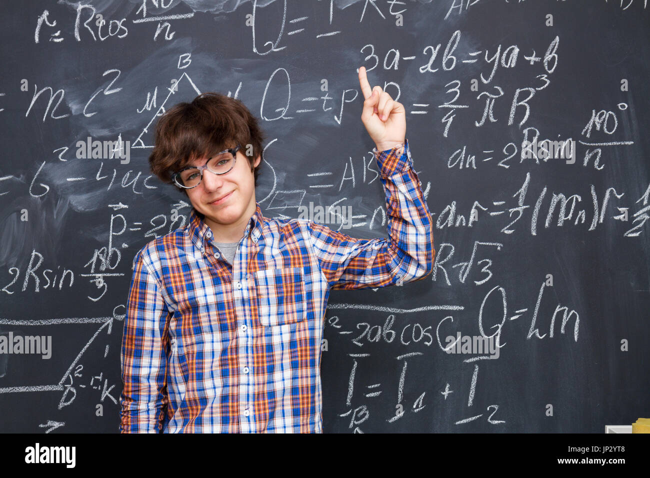 Boy and blackboard filled with math formulas Stock Photo - Alamy