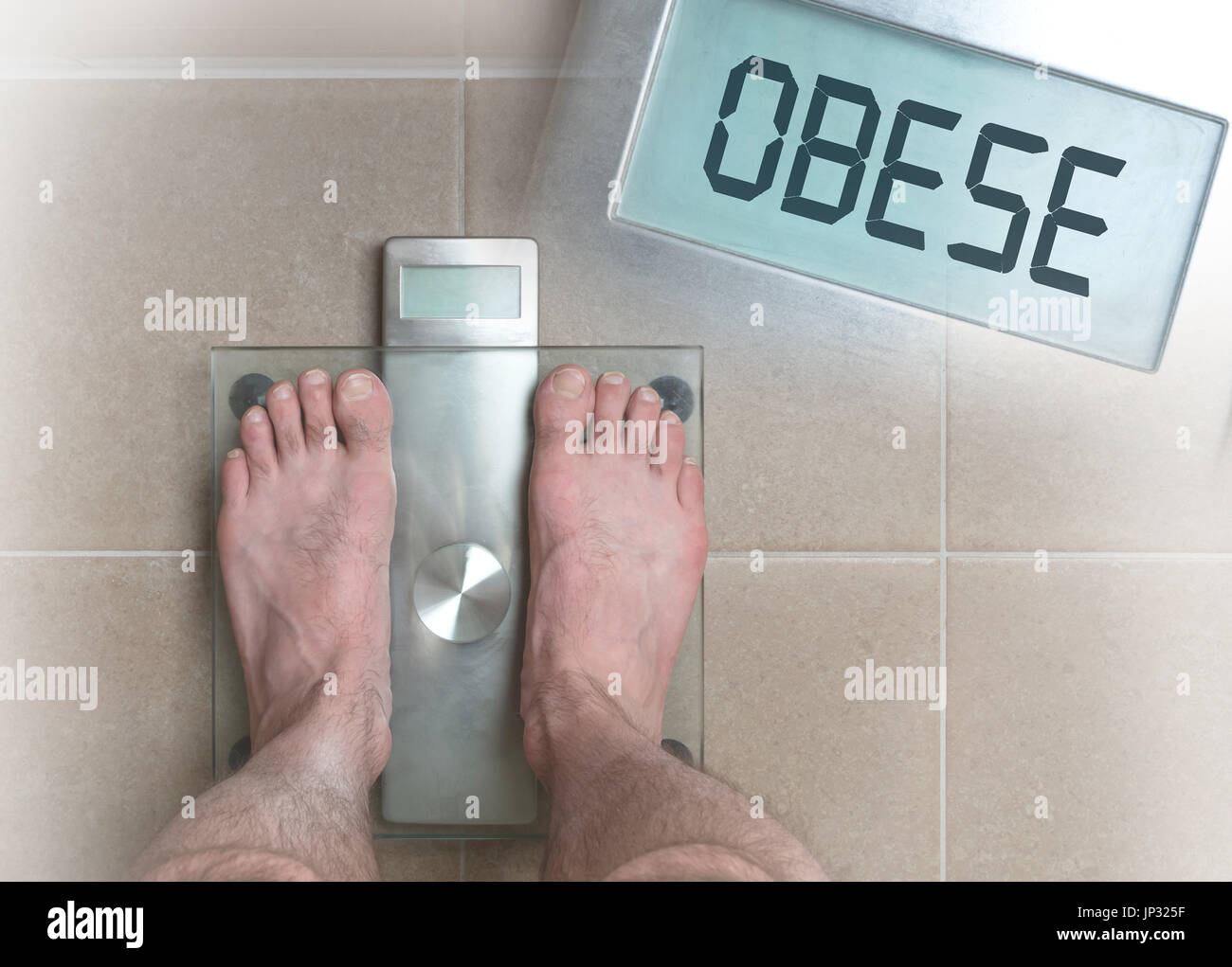 Closeup of man's feet on weight scale - Obese Stock Photo - Alamy