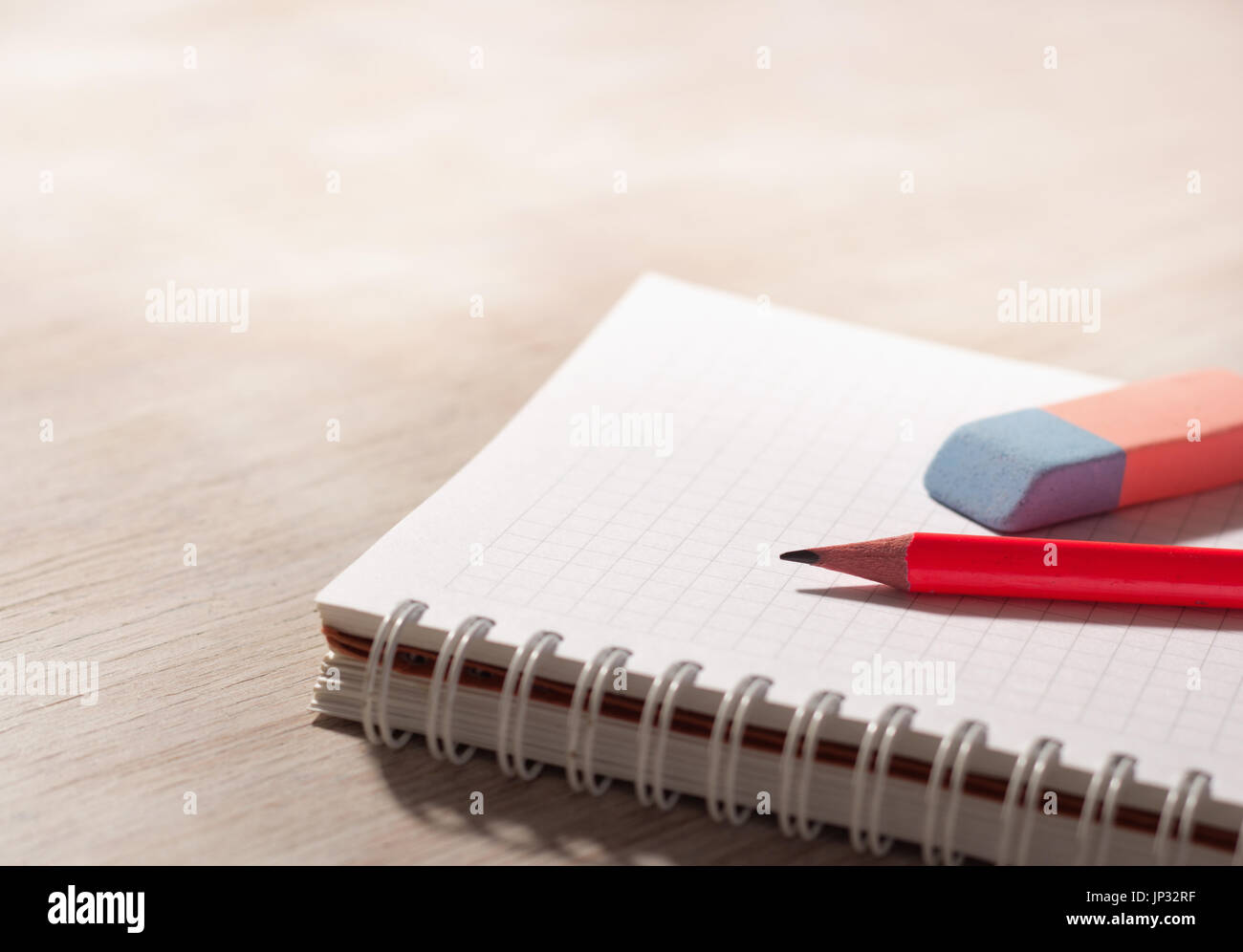 Pencil and eraser on blank spiral notebook on desk. Place for your text ...