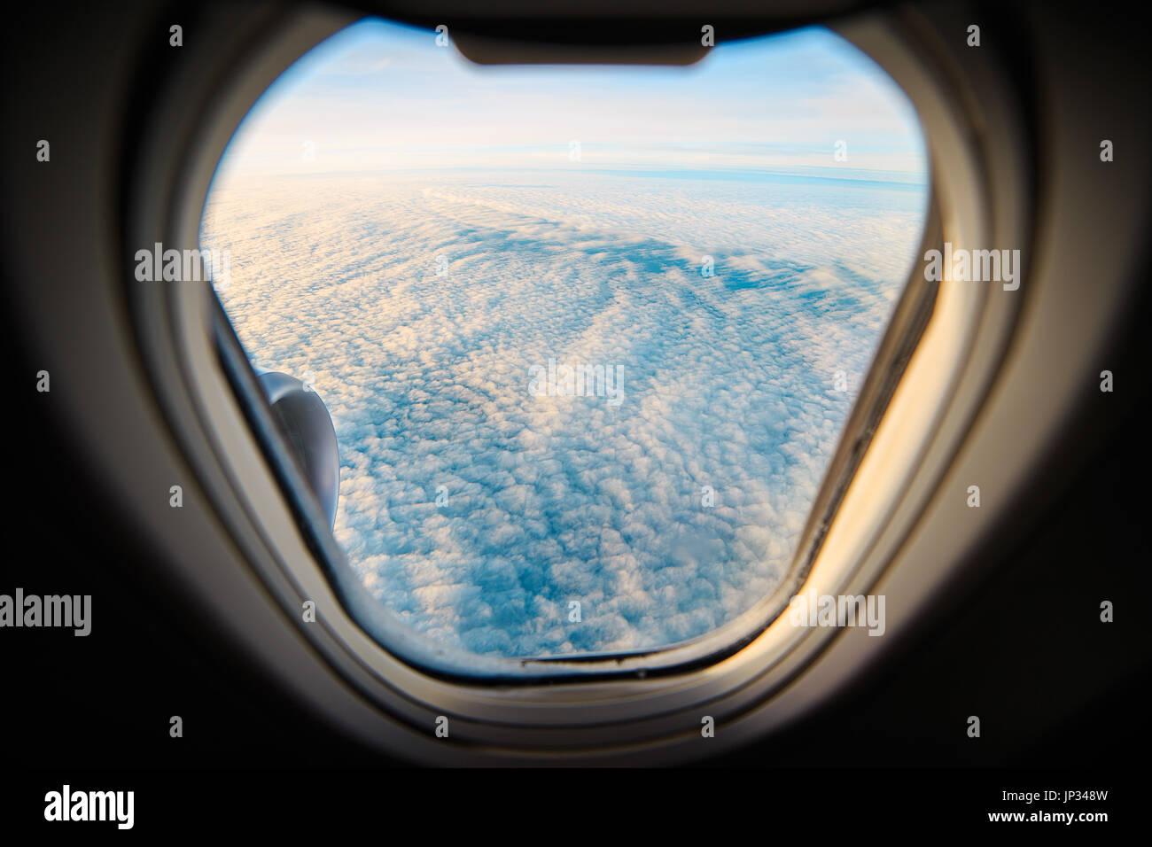 Views from the window of an airplane flying towards Iceland. Through ...