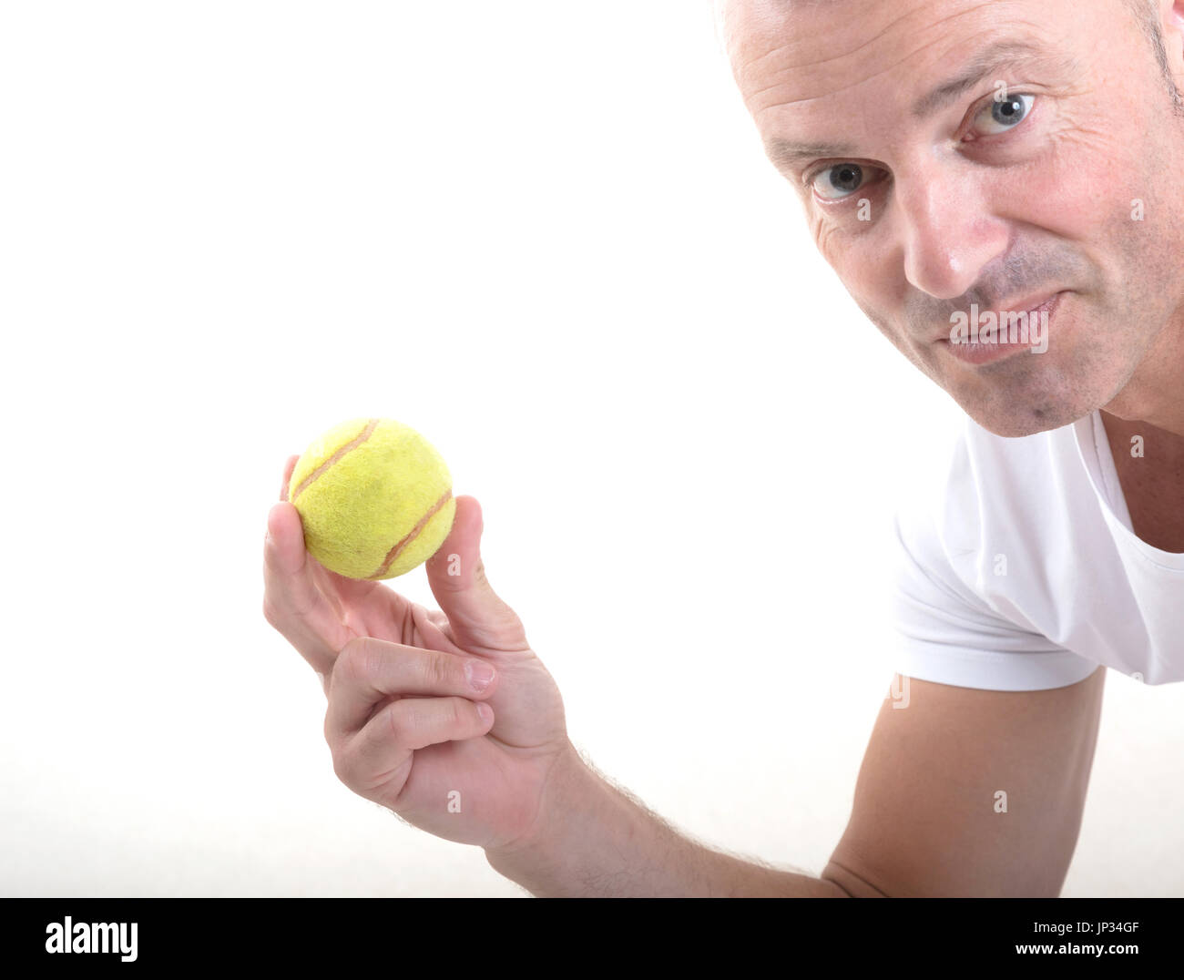 Tennis ball in hand, isolated on white background Stock Photo - Alamy