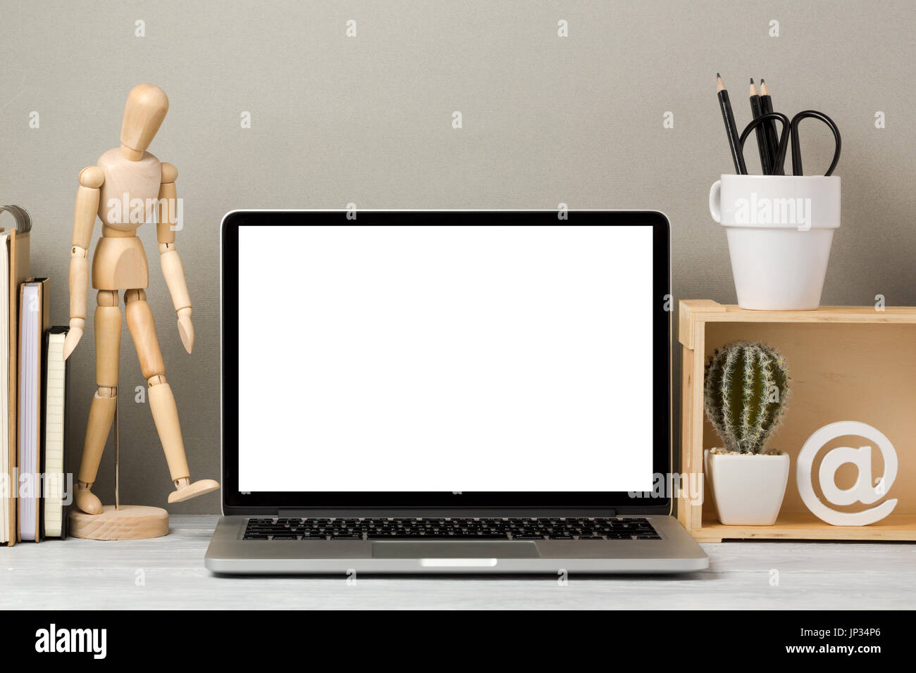 Laptop computer mock up with pencil and wooden dummy. Modern stylish ...