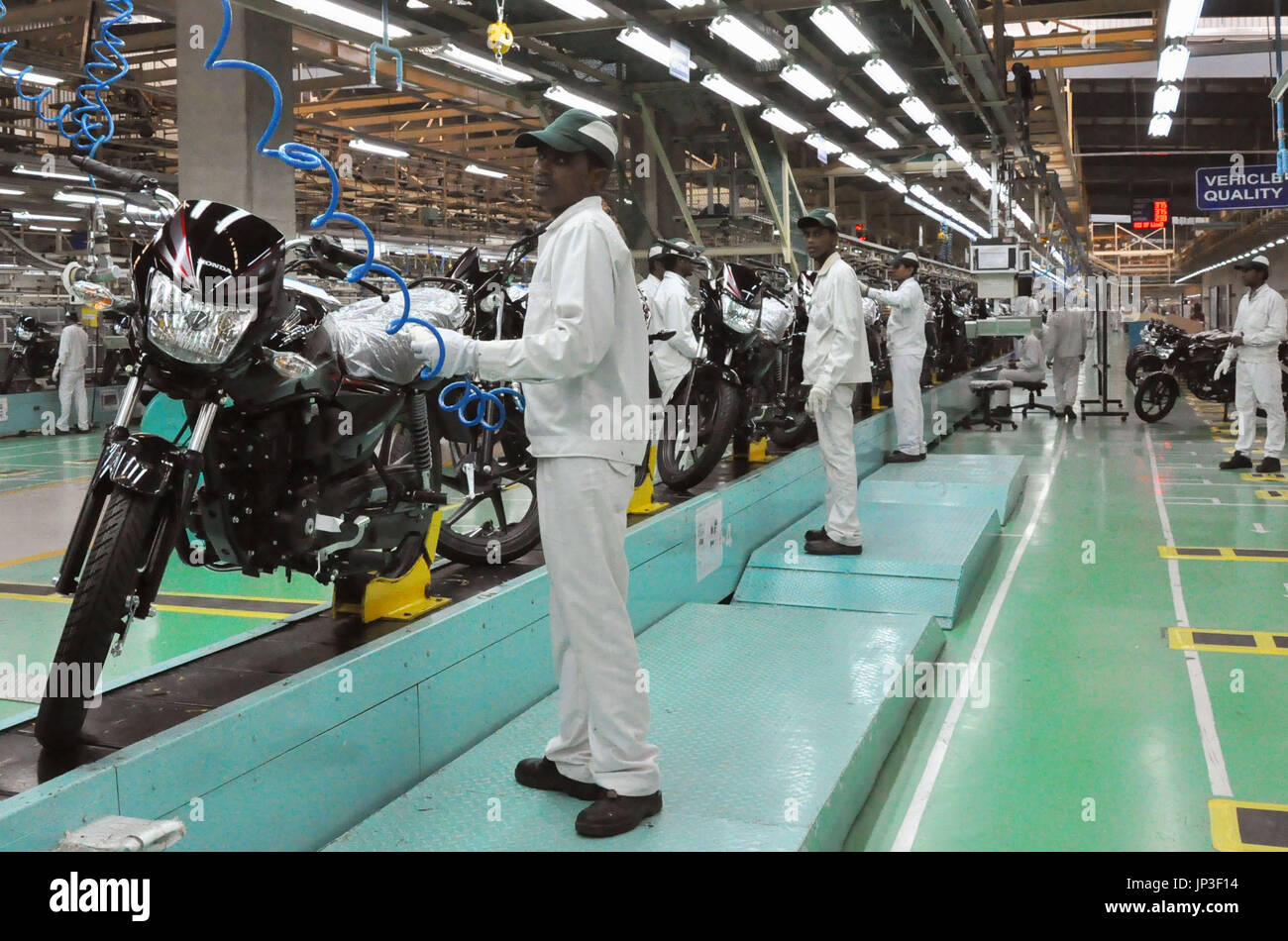 BANGALORE, India - Indian employees assemble motorbikes at a factory ...
