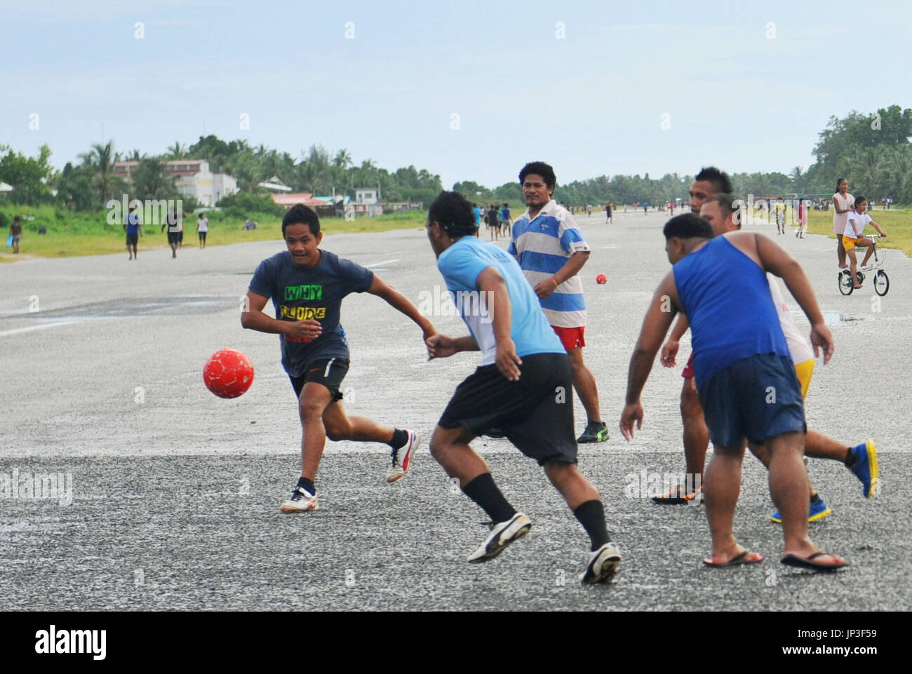 FUNAFUTI, Tuvalu - Young men play football on the international airport ...