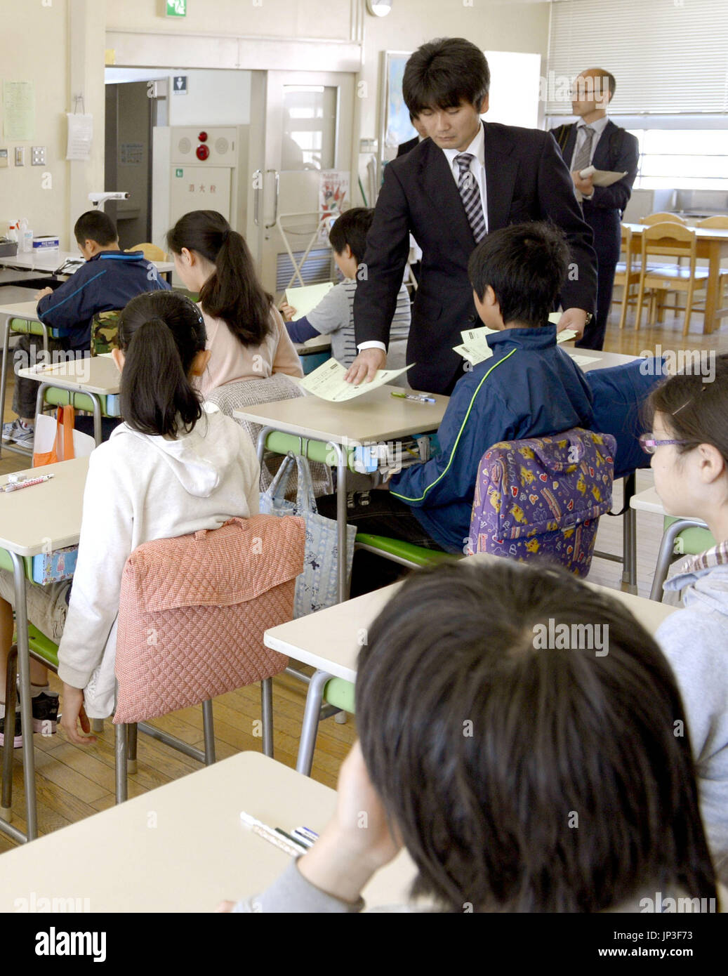 TOKYO, Japan - Pupils take a national achievement examination at an ...