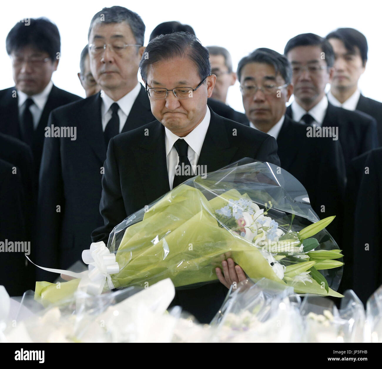 AMAGASAKI, Japan - West Japan Railway Co. President Seiji Manabe offers flowers at the site of a ...