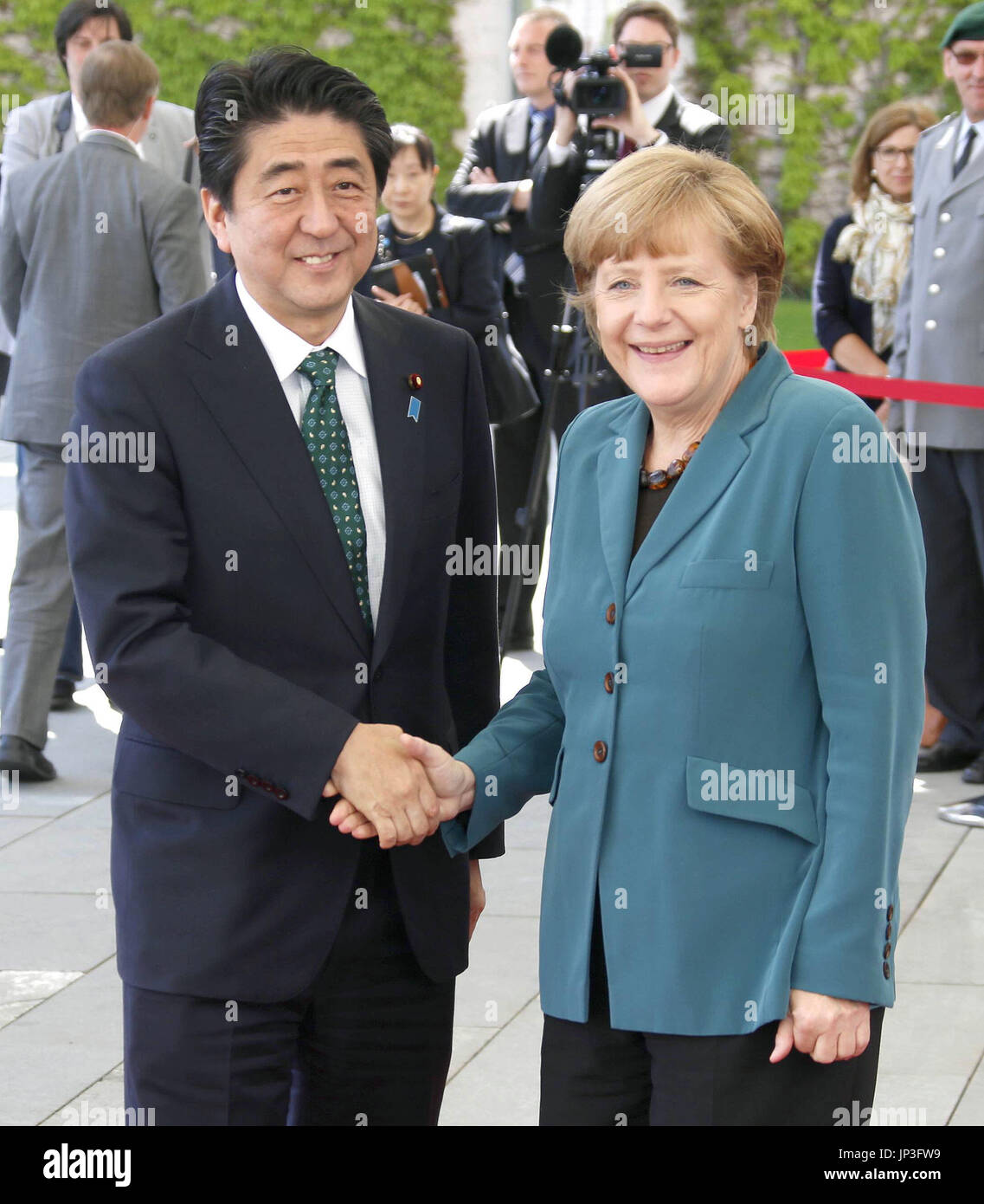 BERLIN, Germany - Japanese Prime Minister Shinzo Abe (L) shakes hands ...