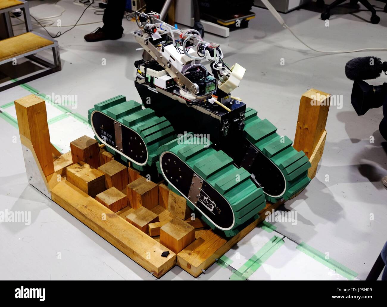 KYOTO, Japan - "Kohga3," a remote-controlled rescue robot, goes over an ...