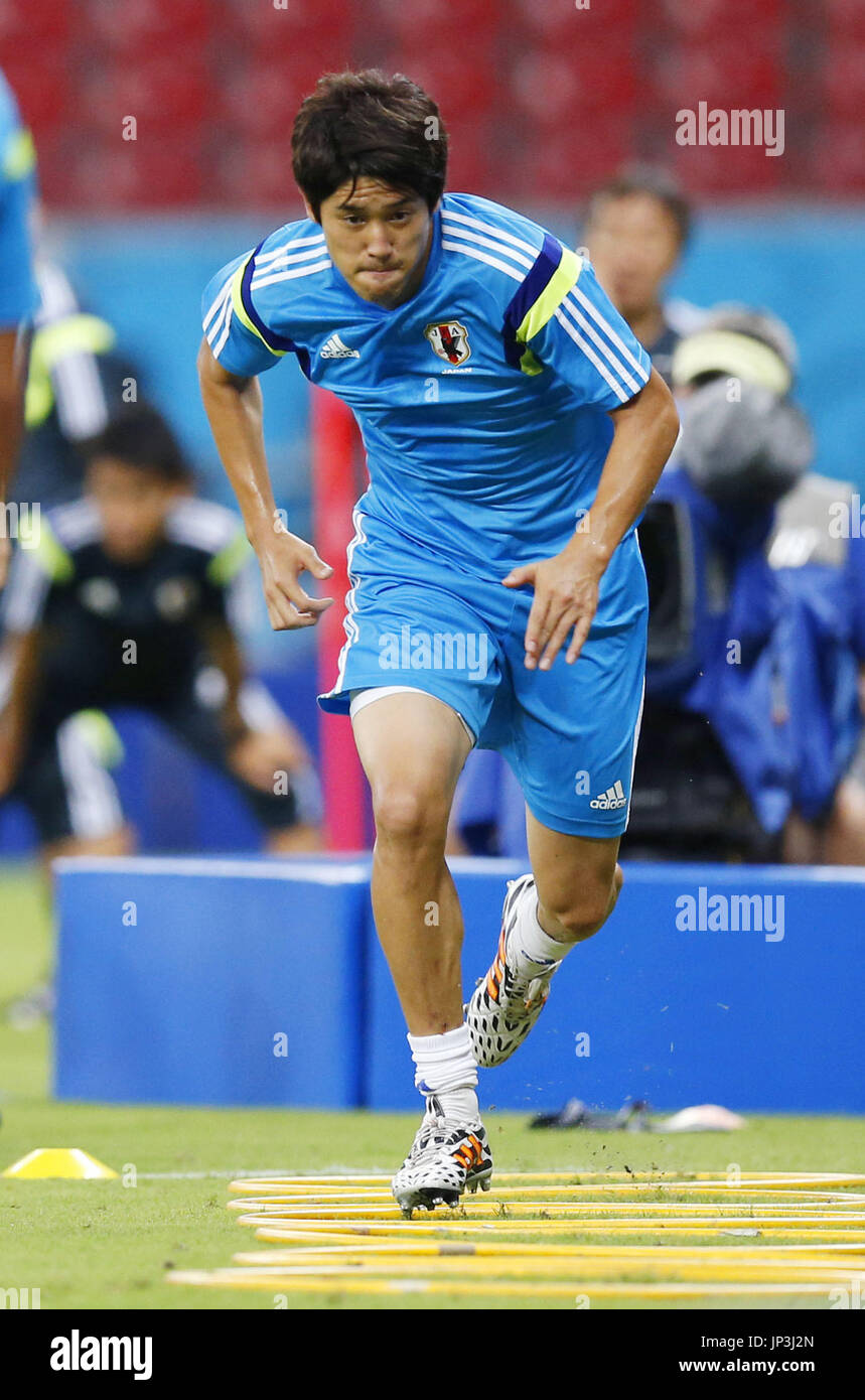 RECIFE, Brazil - Japan national team defender Atsuto Uchida goes through a warm-up on June 13 ...