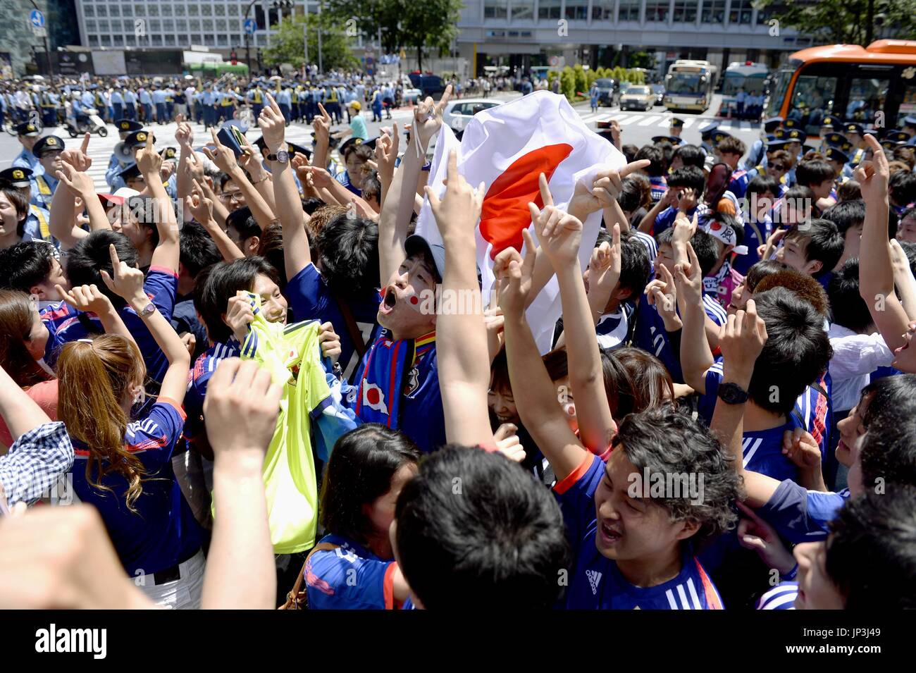 TOKYO, Japan - Japanese supporters cheer on a scramble crossing in ...