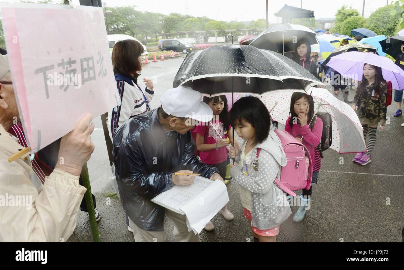 WATARI, Japan - Pupils line up for a designated safety confirmation ...