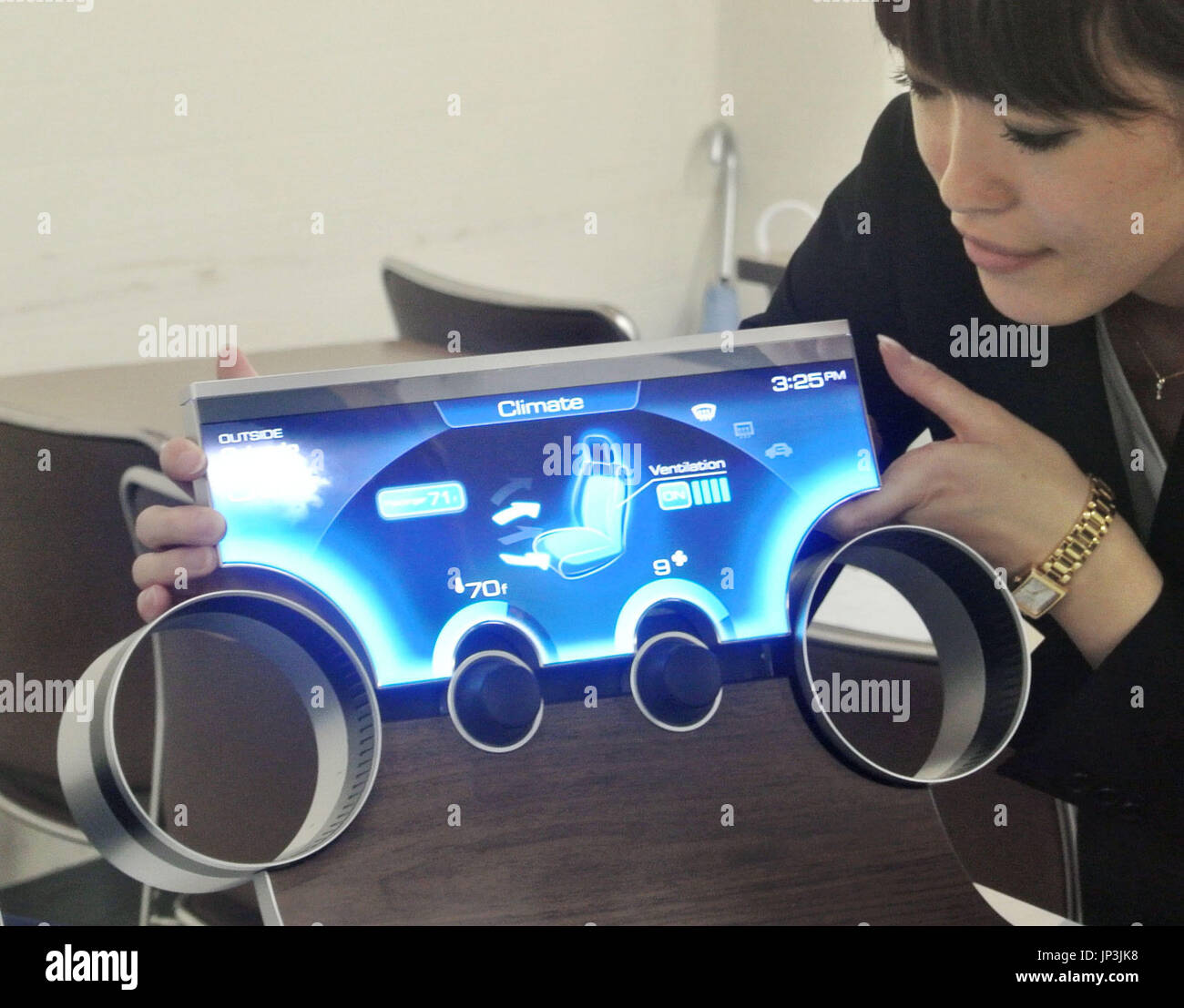 OSAKA, Japan - A woman holds up Sharp Corp.'s Free-Form Display during ...