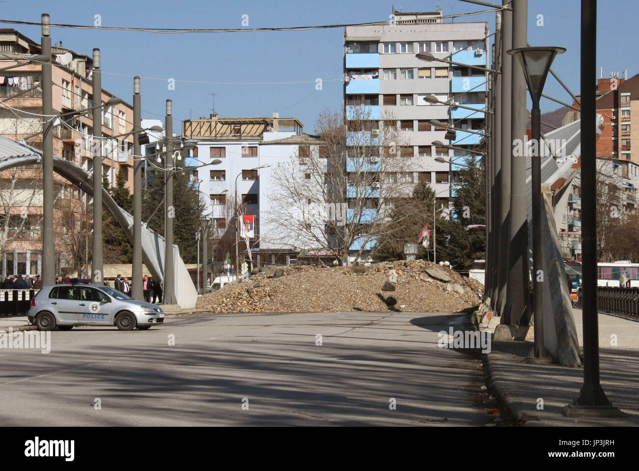 MITROVICA, Kosovo - A barricade on a bridge separating the residential ...