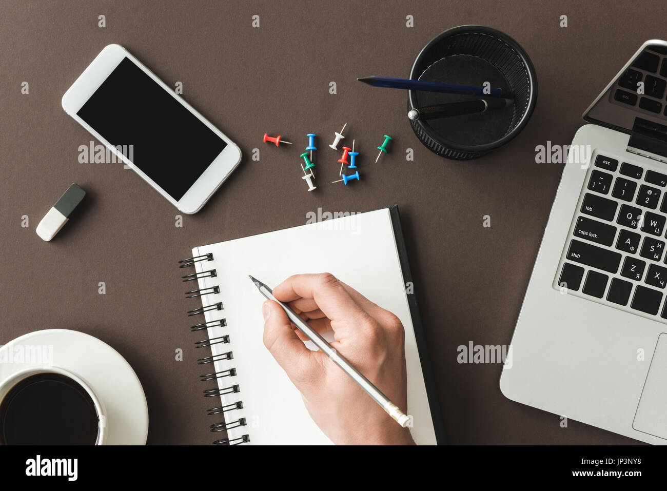 top view of man writing in notebook on home office table Stock Photo ...