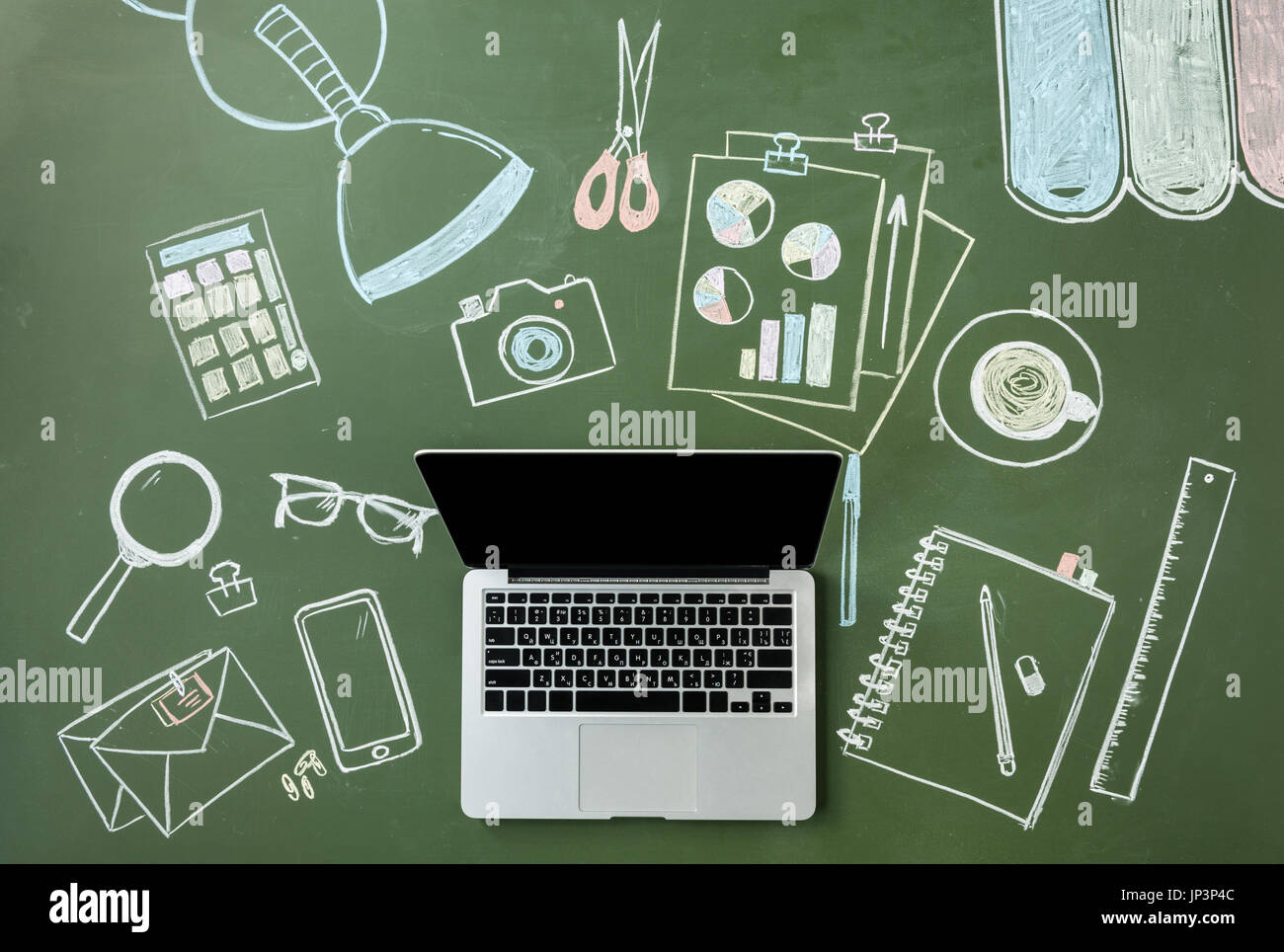 top view of laptop computer and pictures on green board, small office ...