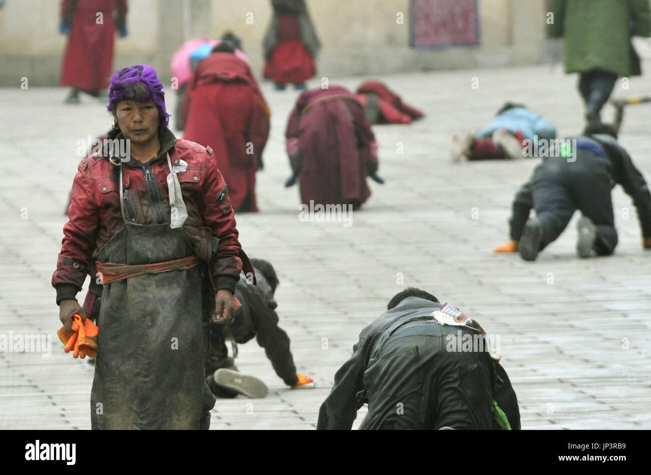 BEIJING, China - Pilgrims lay their bodies on the ground to offer ...