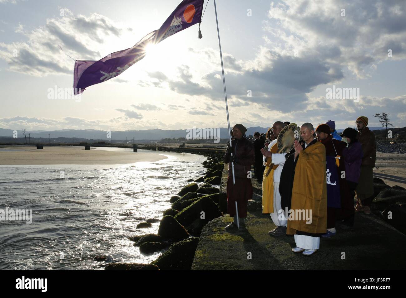 MINAMISOMA, Japan - Residents and Buddhist monks pray to the sea during ...