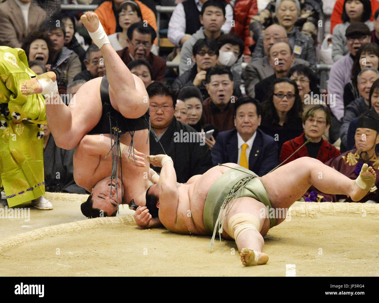 OSAKA, Japan - Yokozuna Harumafuji (L) goes topsy-turvy after defeating ...